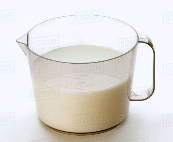Fresh milk in a measuring jug - Royalty-free Stock Photo | Dissolve