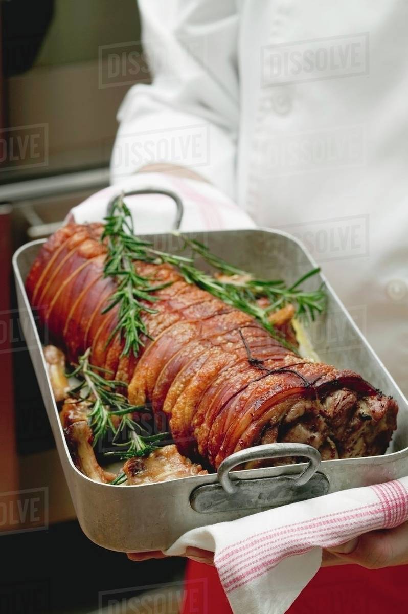 Boned and rolled saddle of suckling pig in a roasting dish - Stock ...