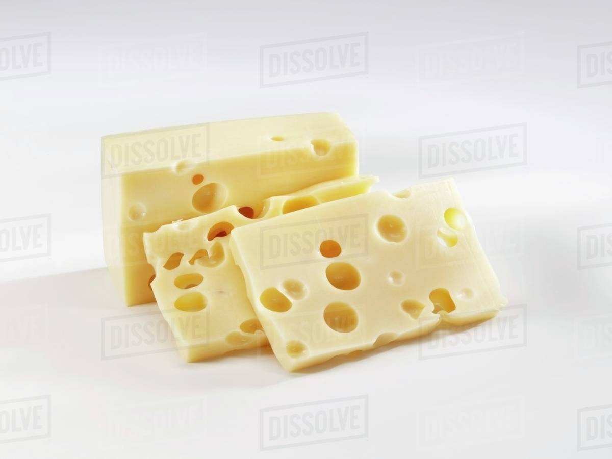 A piece of Emmental cheese and two slices - Royalty-free Stock Photo ...