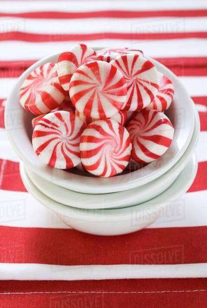 Starlite Mints (peppermints, USA) in white bowl - Stock Photo - Dissolve