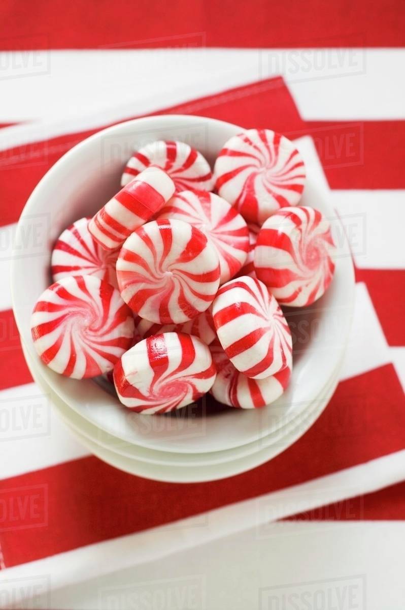 Starlite Mints (peppermints, USA) in white bowl - Stock Photo - Dissolve