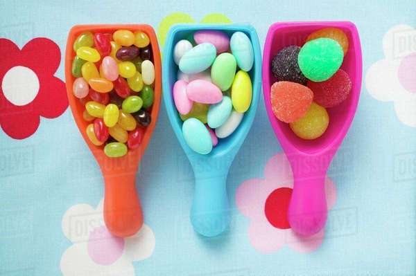 Assorted coloured sweets in plastic scoops - Royalty-free Stock Photo ...