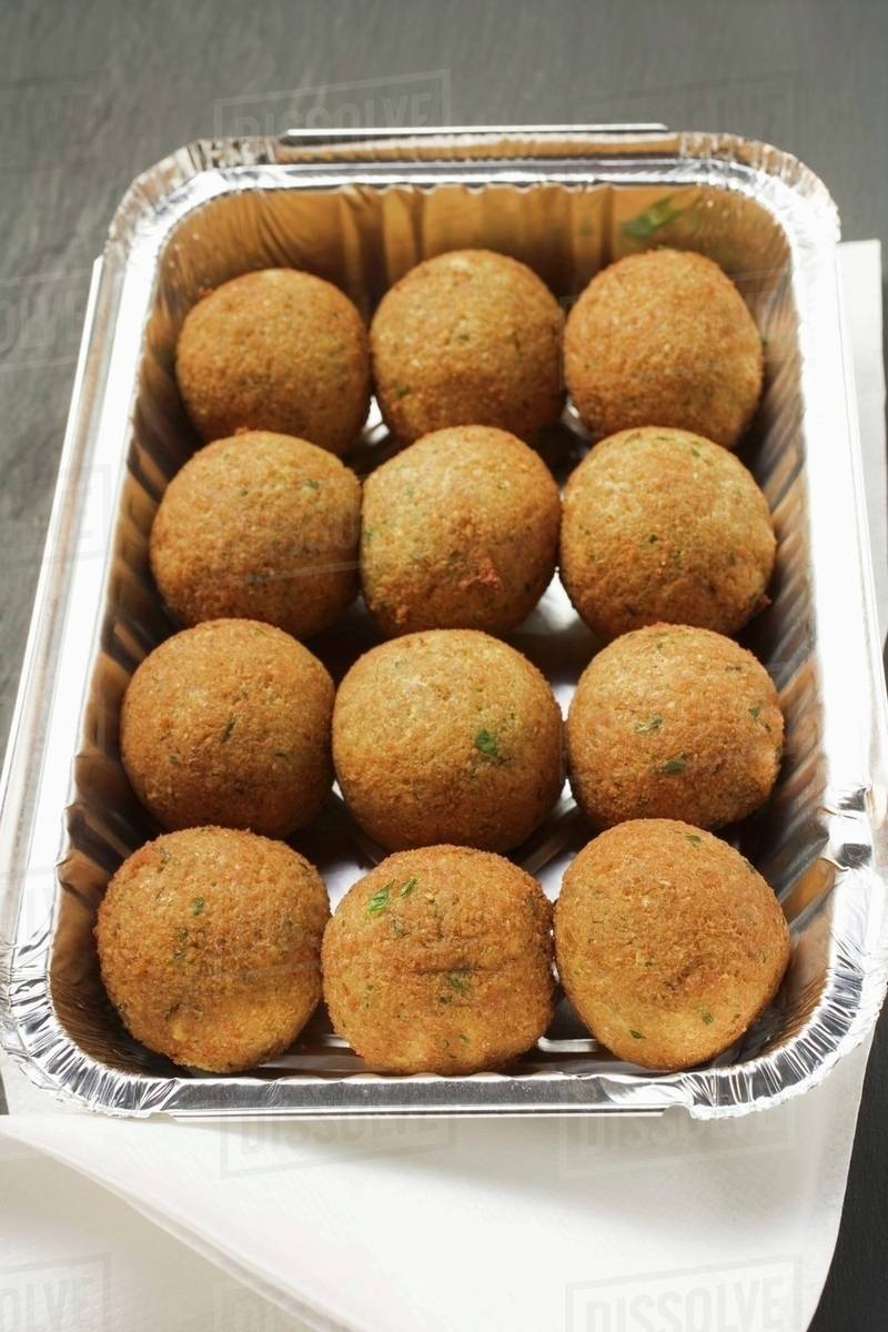 Falafel (chick-pea balls) in aluminium container - Stock Photo - Dissolve
