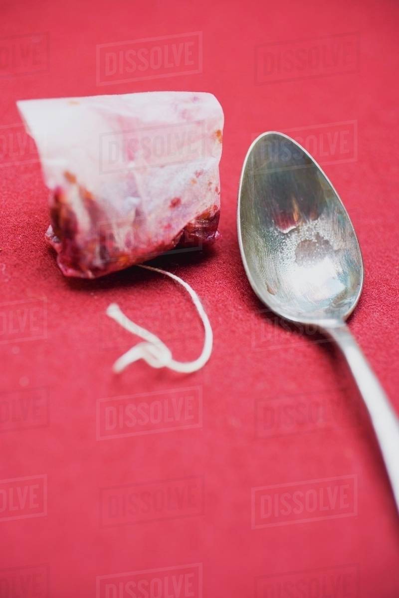 Rose hip tea bag, spoon beside it - Royalty-free Stock Photo | Dissolve
