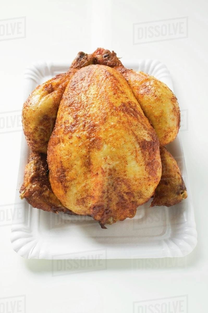 Whole roast chicken on paper plate - Royalty-free Stock Photo | Dissolve