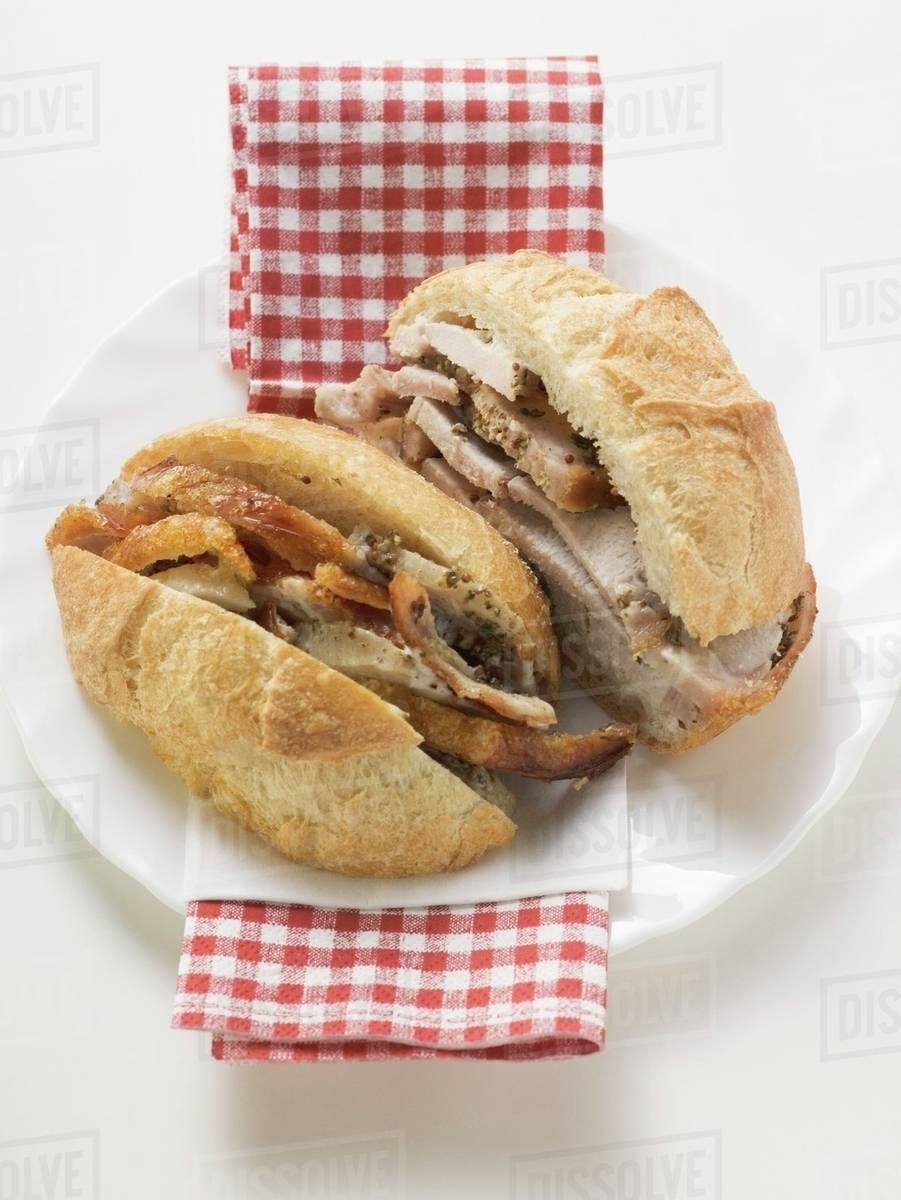 Roast pork in bread roll, halved, on napkin - Royalty-free Stock Photo ...