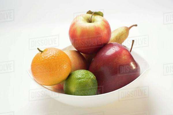 Core fruit and citrus fruit in white bowl - Royalty-free Stock Photo ...
