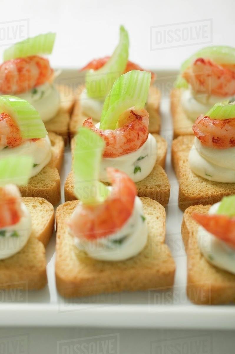 Herb quark, shrimps and celery on toasts - Stock Photo - Dissolve