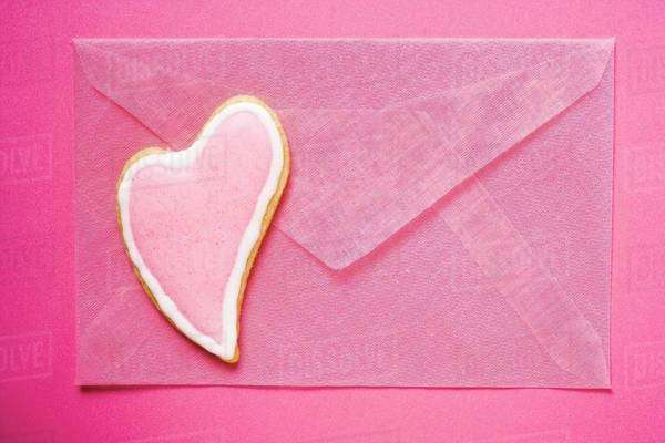 Pink envelope with heart-shaped biscuit - Royalty-free Stock Photo ...