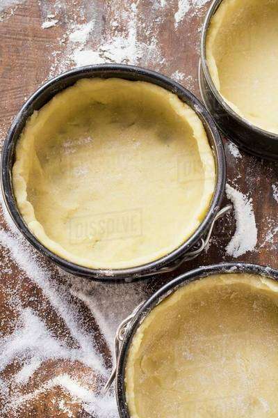 Baking tins lined with pastry - Stock Photo - Dissolve