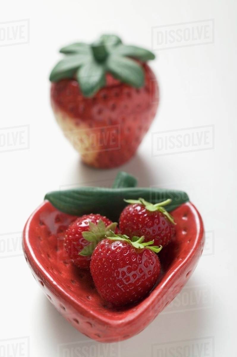 Three strawberries in red strawberry-shaped dish - Royalty-free Stock ...