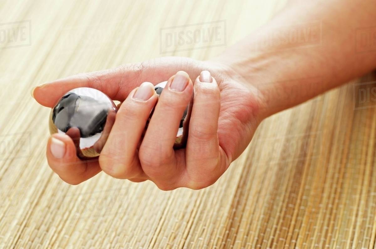 Qi gong balls in a woman's hands - Royalty-free Stock Photo | Dissolve