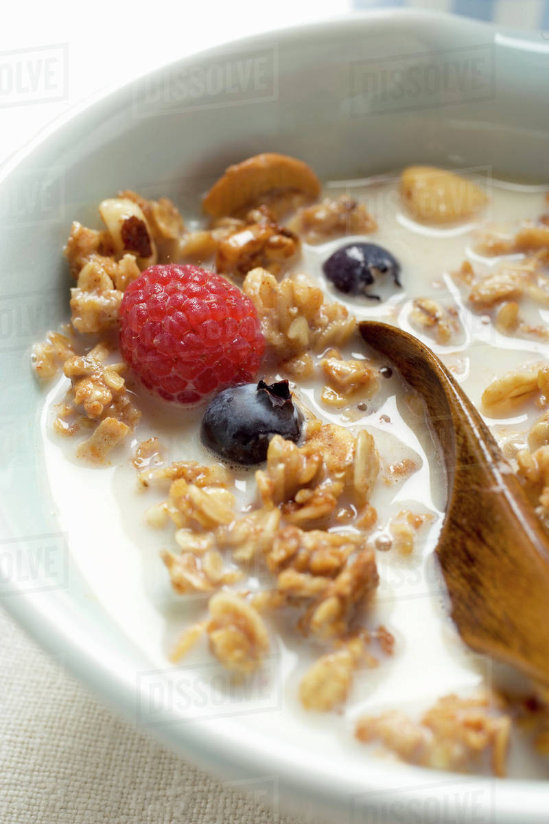 Crunchy muesli with berries and milk - Royalty-free Stock Photo | Dissolve