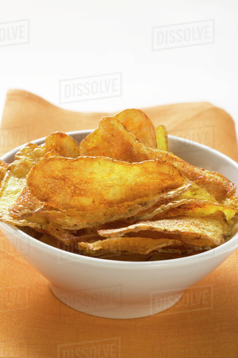 Potato crisps in bowl - Royalty-free Stock Photo | Dissolve