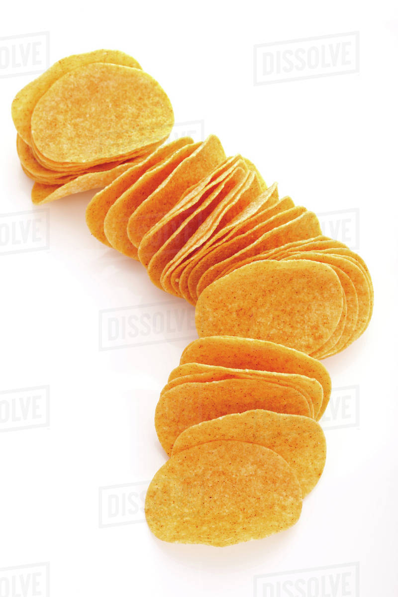 Potato chips in a row, elevated view - Stock Photo - Dissolve