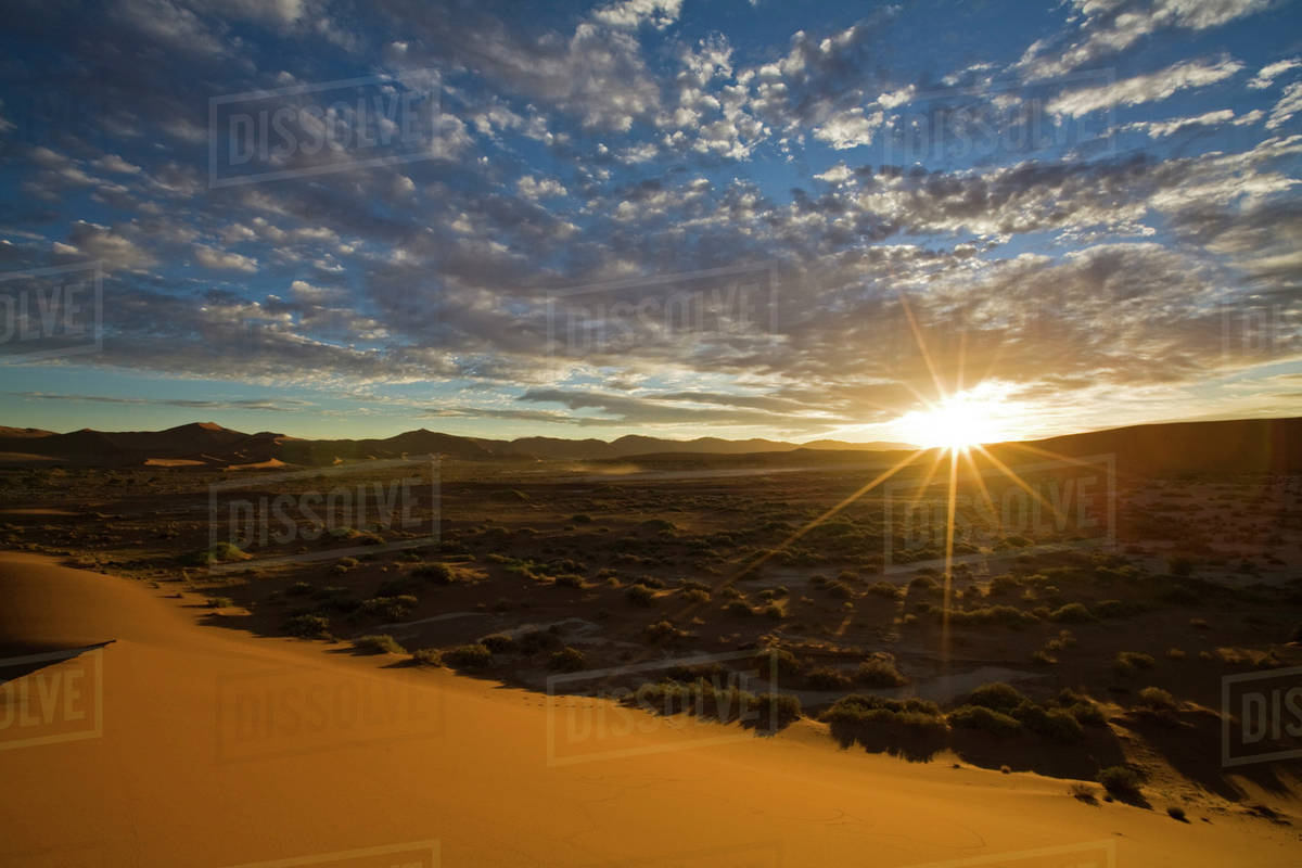 Africa, Namibia, Sun rising over Namib Desert - Stock Photo - Dissolve