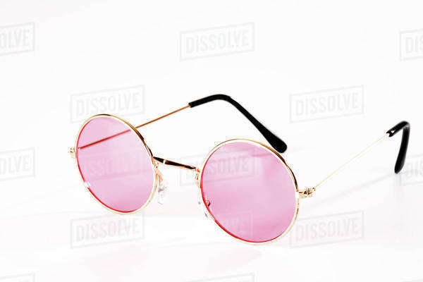 Pink metal-rimmed spectacles - Stock Photo - Dissolve