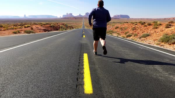Man running down the road from Forrest Gump Point towards Monument ...