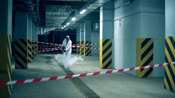 Chemical fumigation of an empty storage space. Worker disinfecting ...