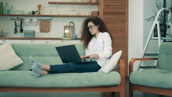 Gorgeous lady is laughing while using gadgets in self-isolation. Work ...