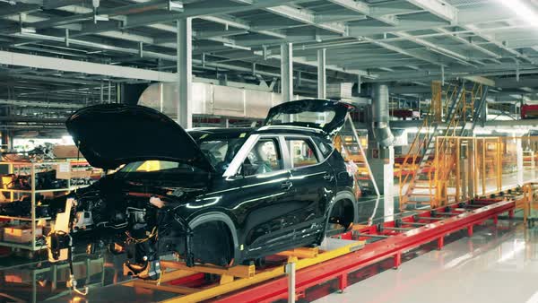 Black car body moving on assembly line. Car production factory interior ...