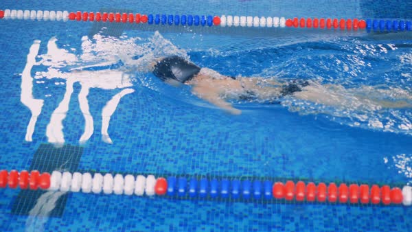 A side view on a female swimmer demonstrating crawl strokes. - Stock ...