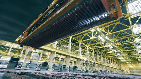 Industrial loader relocating metal being filmed from below - 4K Royalty ...