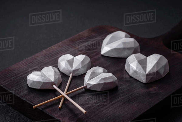 Beautiful tasty sweet candies in gray color on a dark concrete ...