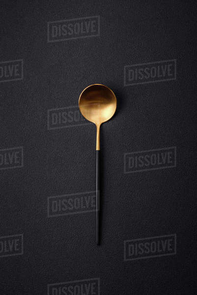 Empty metal spoon on dark textured concrete background. Cutlery ...