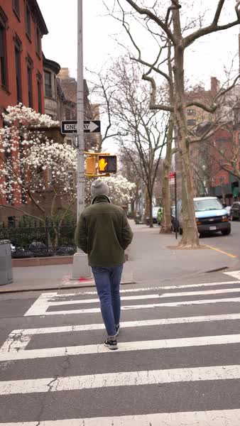 Medium shot of a man crossing street in city - 4K Royalty-free Stock ...