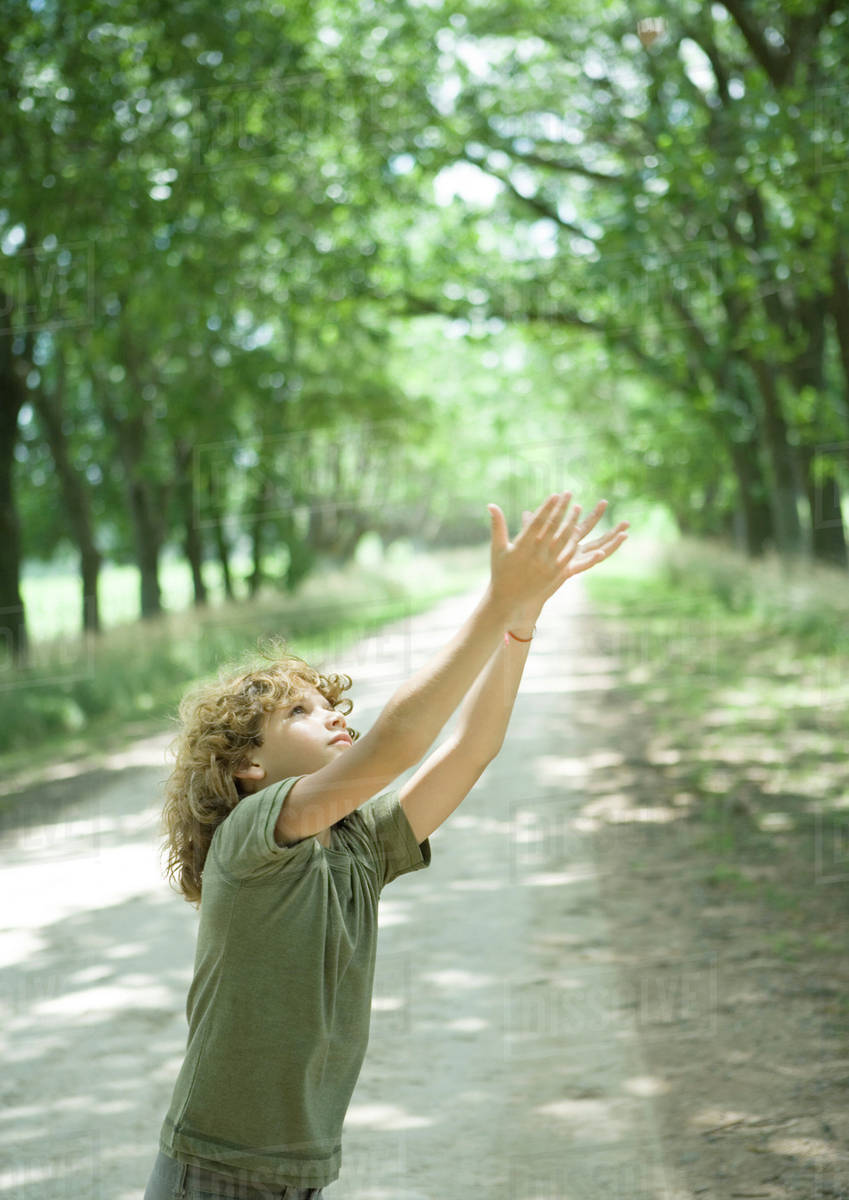 Boy catching rock - Stock Photo - Dissolve