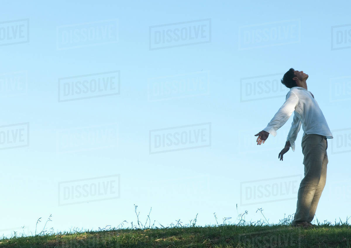 Man standing outside with arms and head back - Royalty-free Stock Photo ...
