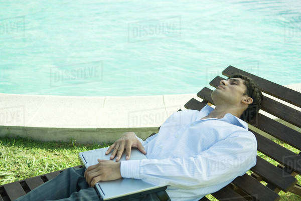 Businessman reclining on lounge chair - Royalty-free Stock Photo | Dissolve