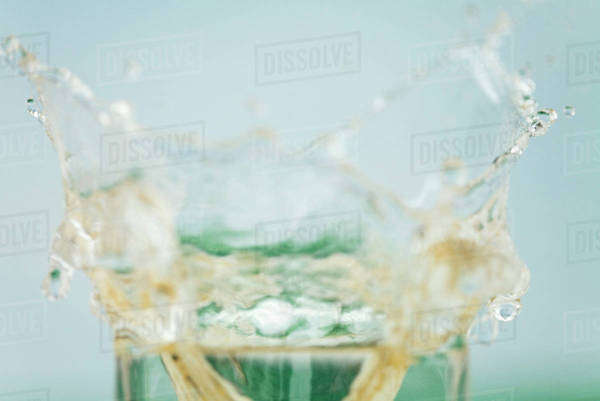 Water splashing out of glass - Royalty-free Stock Photo | Dissolve