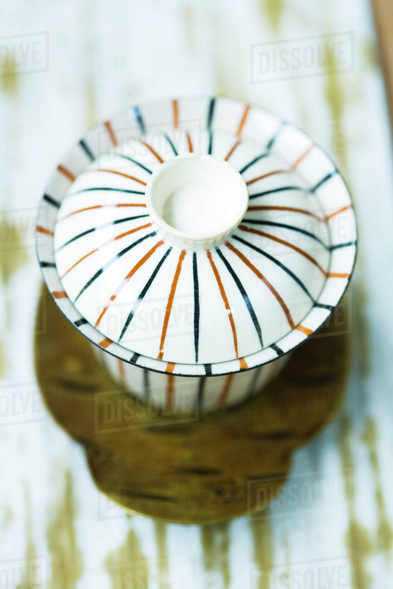 Striped tea cup with lid - Royalty-free Stock Photo | Dissolve