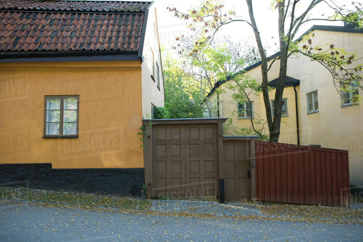 Shed and fence next to building - Royalty-free Stock Photo | Dissolve