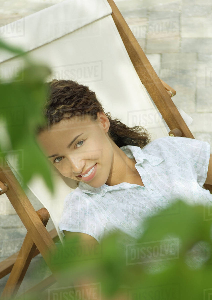 Woman sitting in deck chair, high angle view - Royalty-free Stock Photo ...