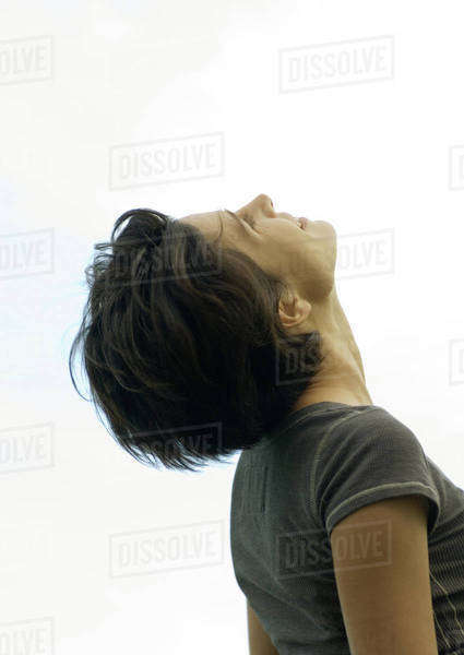 Woman with head back, smiling - Royalty-free Stock Photo | Dissolve