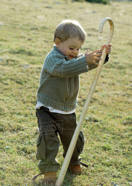 Boy holding cane - Stock Photo - Dissolve
