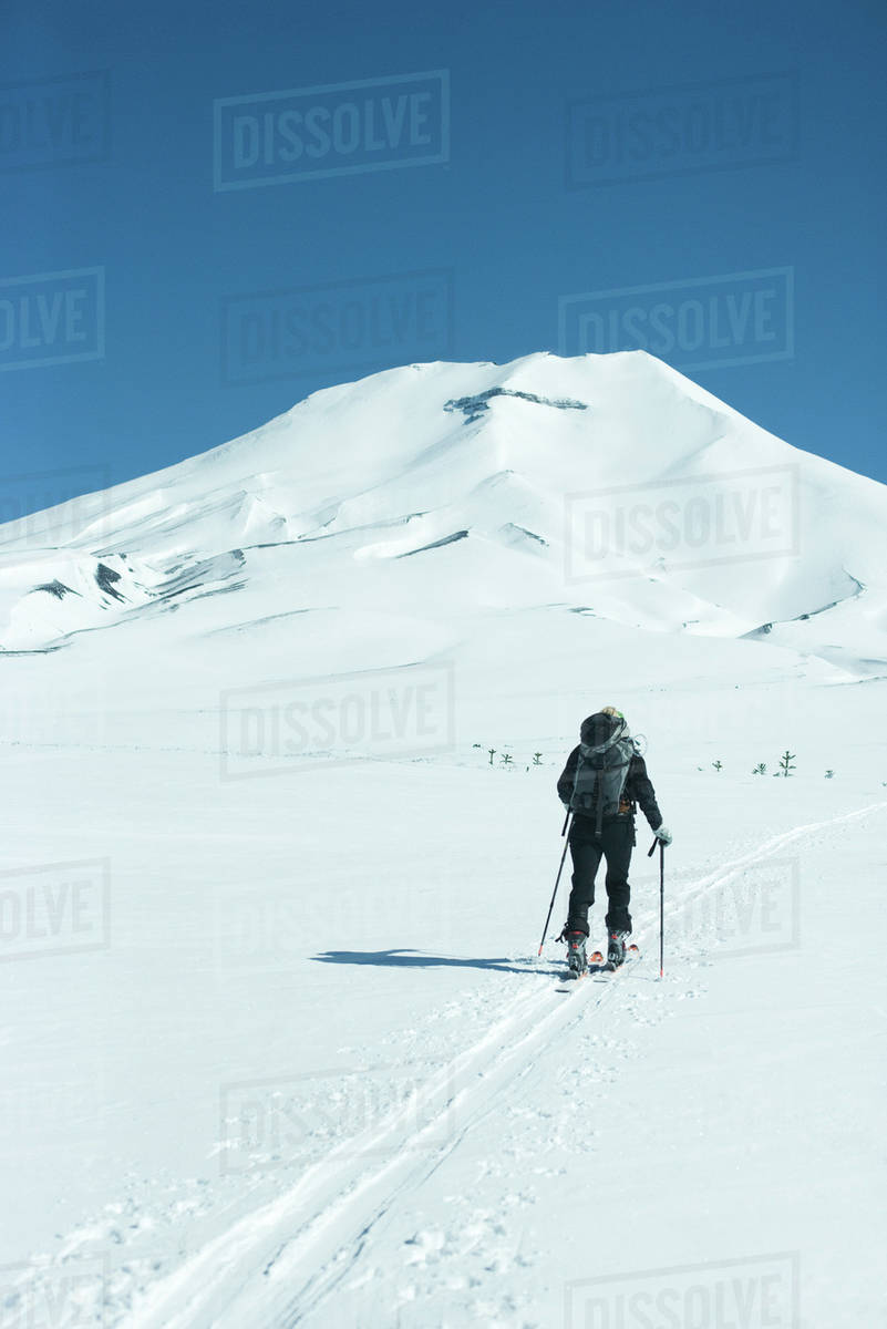 Skier heading toward mountain, rear view - Royalty-free Stock Photo ...