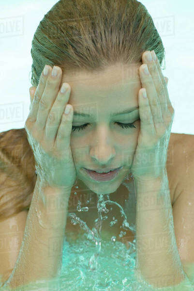 Young woman in pool, splashing face with water - Royalty-free Stock ...