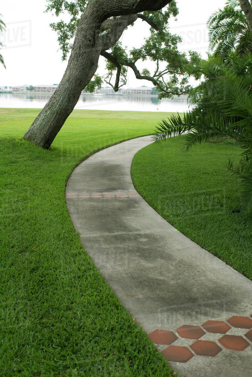 Paved path in waterside park - Royalty-free Stock Photo | Dissolve
