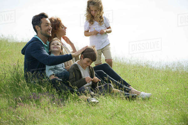 Family relaxing together outdoors - Stock Photo - Dissolve