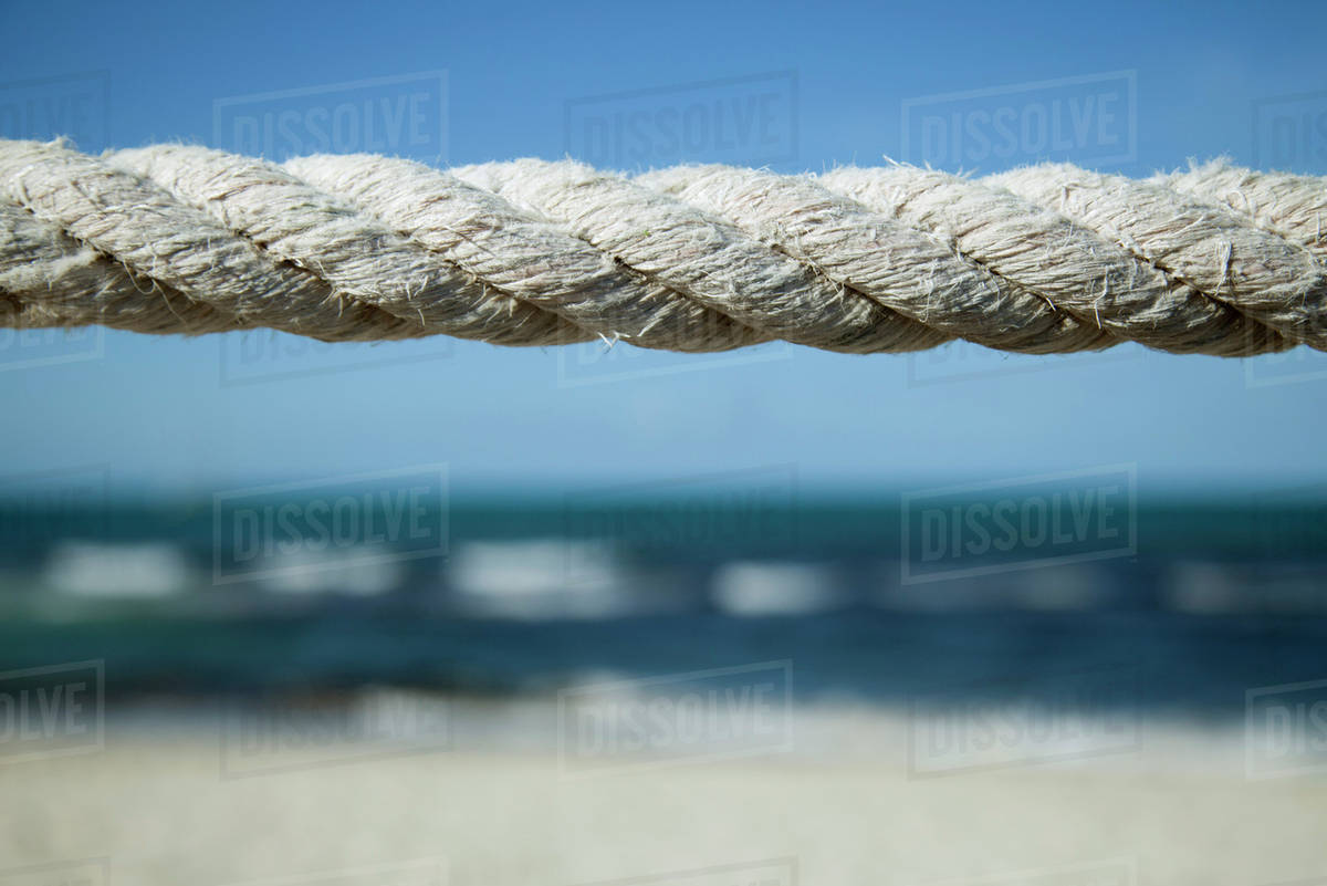 Close-up of weathered rope with beach in background - Stock Photo ...