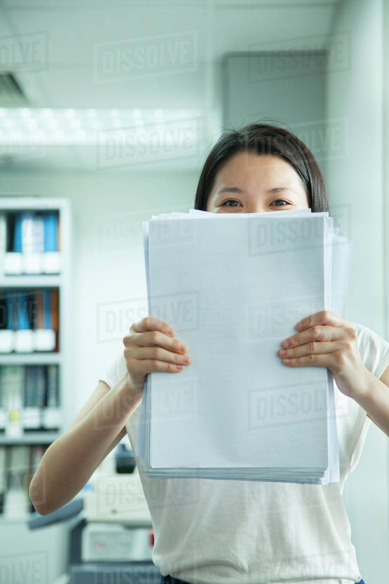 Businesswoman Hiding Behind Paper - Royalty-free Stock Photo | Dissolve