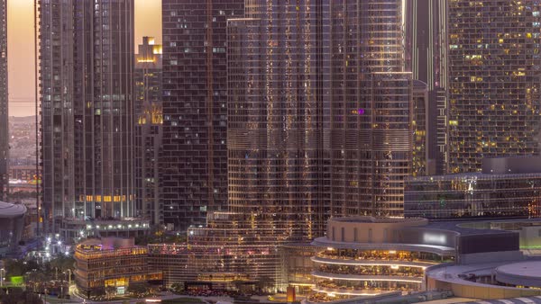 Shopping mall exterior with reastaurants day to night transition ...