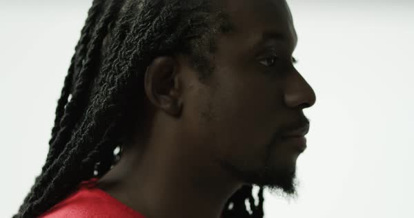 Profile view of confident black man on white background. Half-turned ...