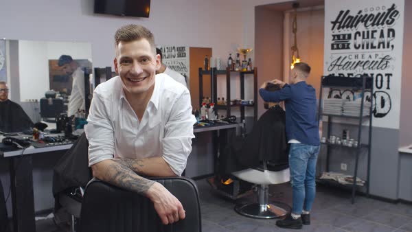 Portrait of handsome young barber smiling at camera - Stock Video ...