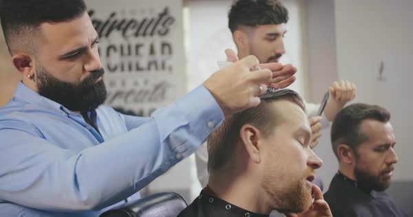 Professional barbers working with clients in barber shop - Stock Video ...