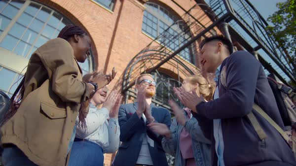 Young beautiful group of students standing shaking hands after ...
